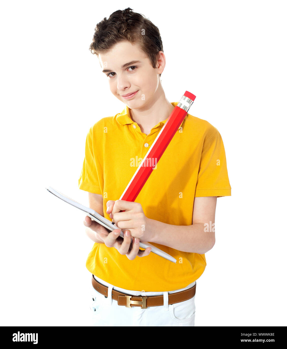 Cute boy writing on his notebook looking at camera Stock Photo - Alamy
