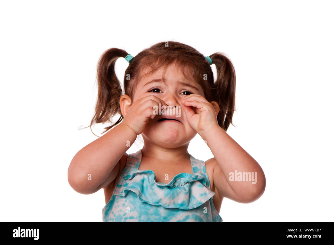 Sad unhappy crying cute little young toddler girl wiping tears, isolated Stock Photo - Alamy