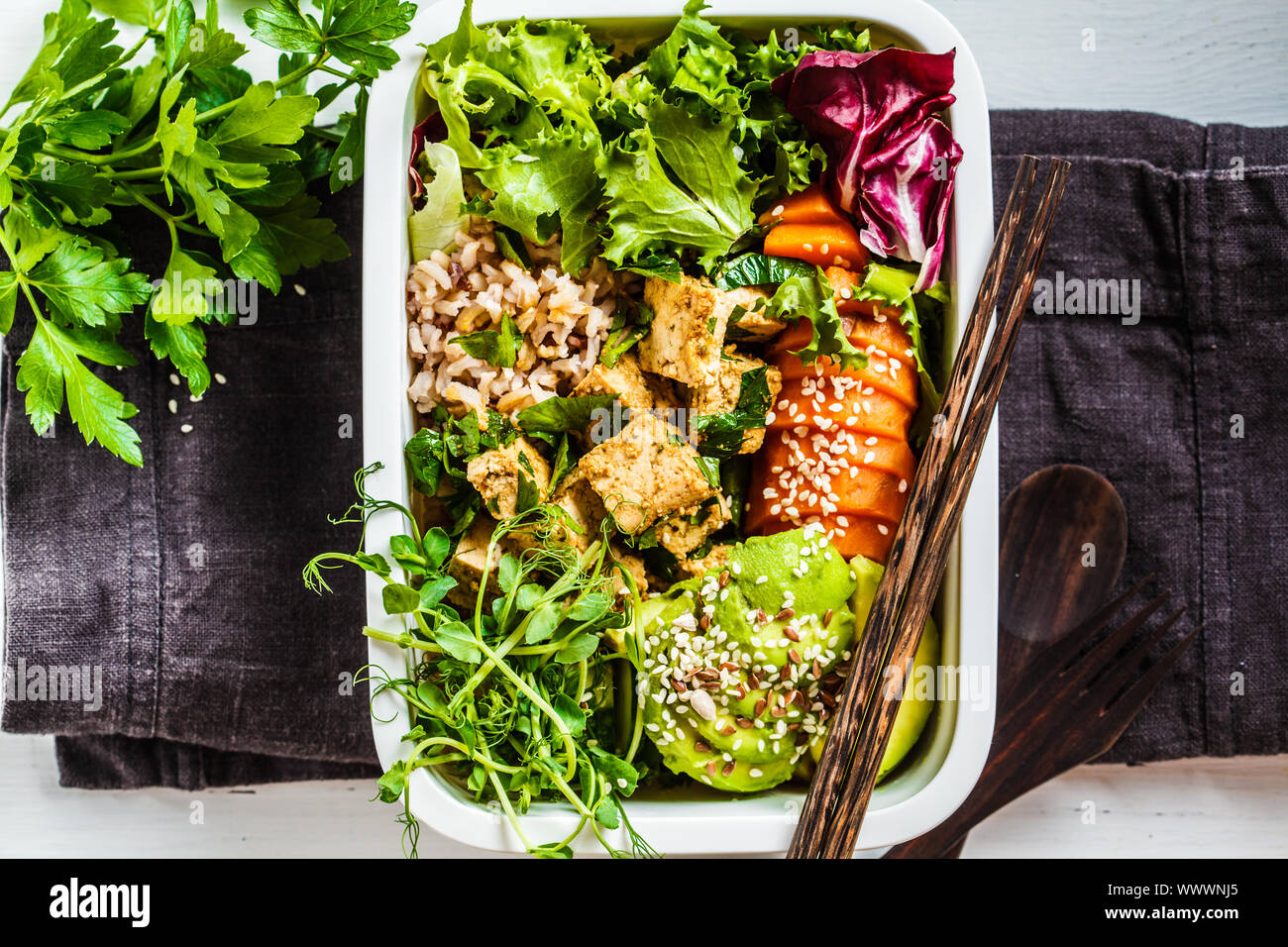 Lunch box with healthy vegan food. Bento box with rice, tofu and ...