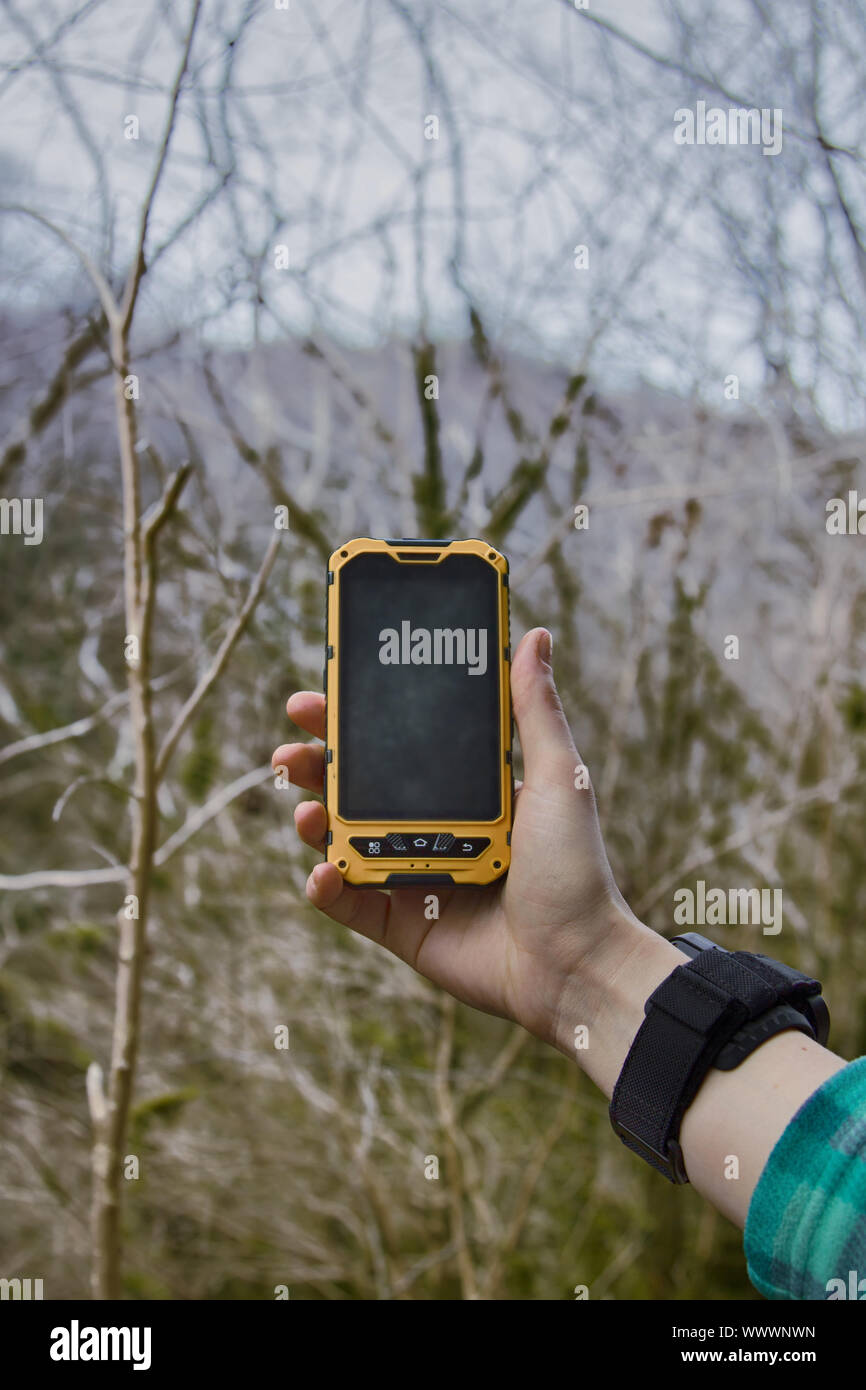 smartphone is ip68 protected in forest background Stock Photo - Alamy