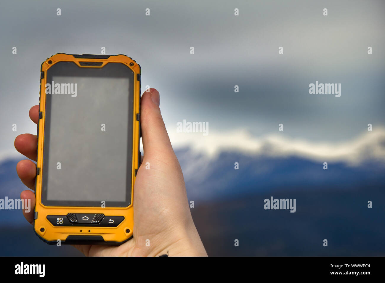 smartphone is ip68 protected in mountains background Stock Photo - Alamy