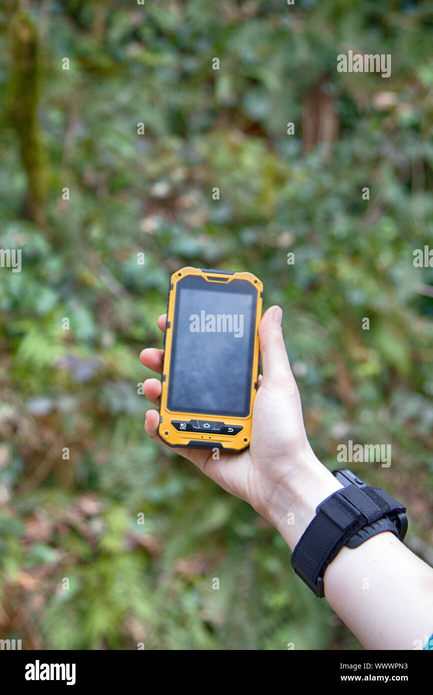 smartphone is ip68 protected in forest background Stock Photo - Alamy