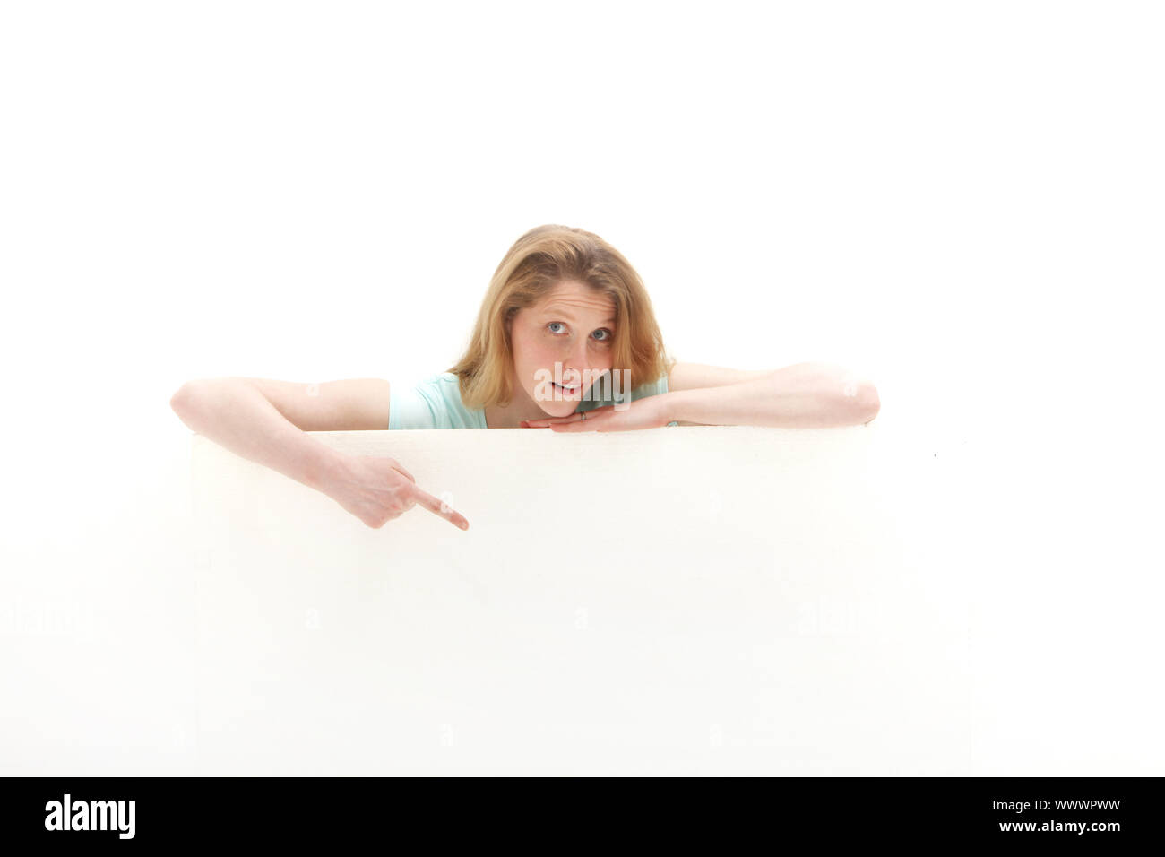 Cute girl pointing to a white poster where you will have your own ...