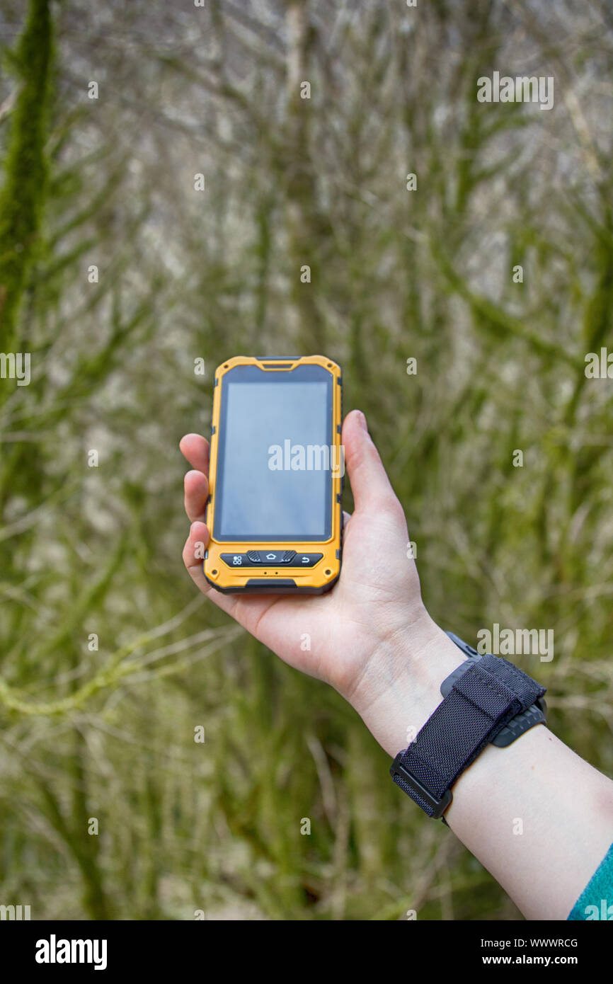 smartphone is ip68 protected in forest background Stock Photo - Alamy
