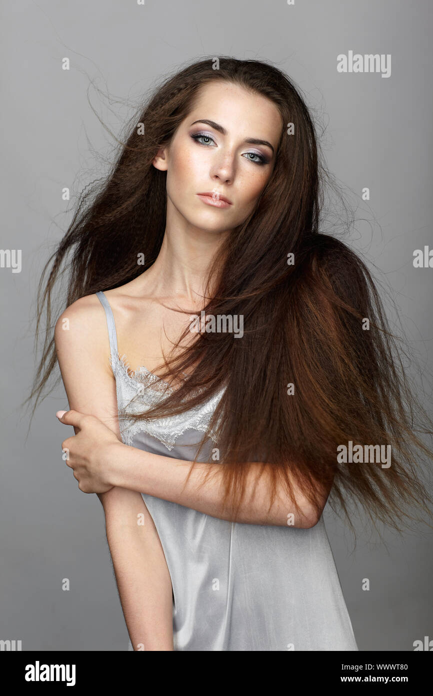 Beauty portrait of young woman. Brunette girl with long disheveled ...