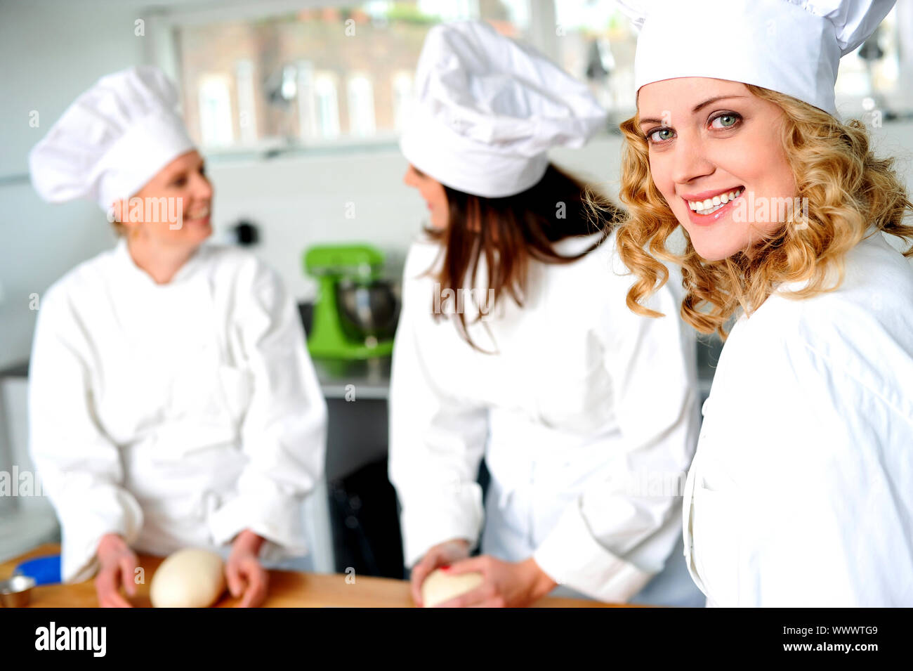Group of professional female chefs in commercial kitchen Stock Photo ...