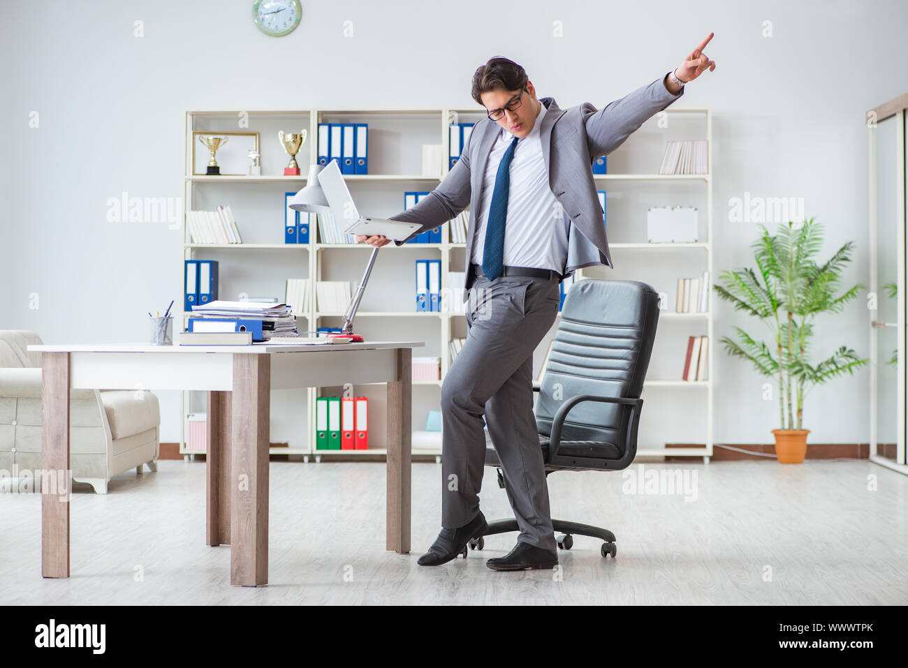 Businessman having fun taking a break in the office at work Stock Photo ...
