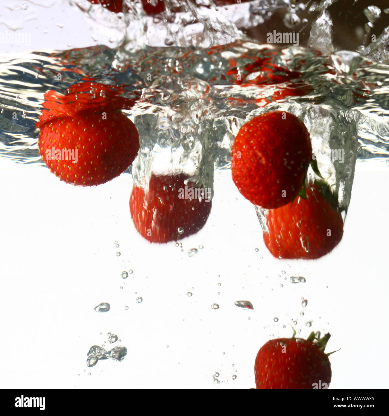 strawberry splash in water isolated on white background Stock Photo - Alamy