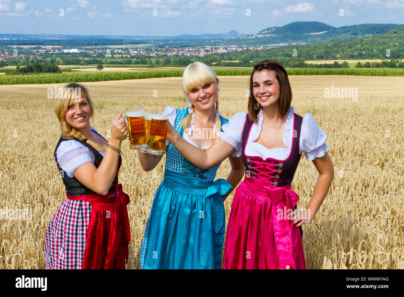 Oktoberfest young women traditional dirndl hi-res stock photography and ...