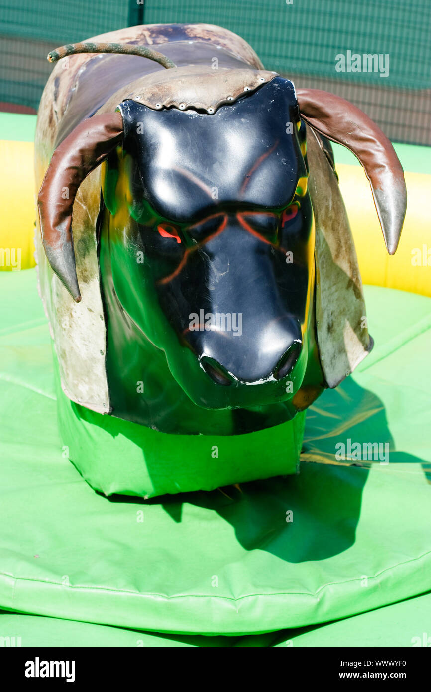 Shabby mechanical bull ride simulator Stock Photo - Alamy