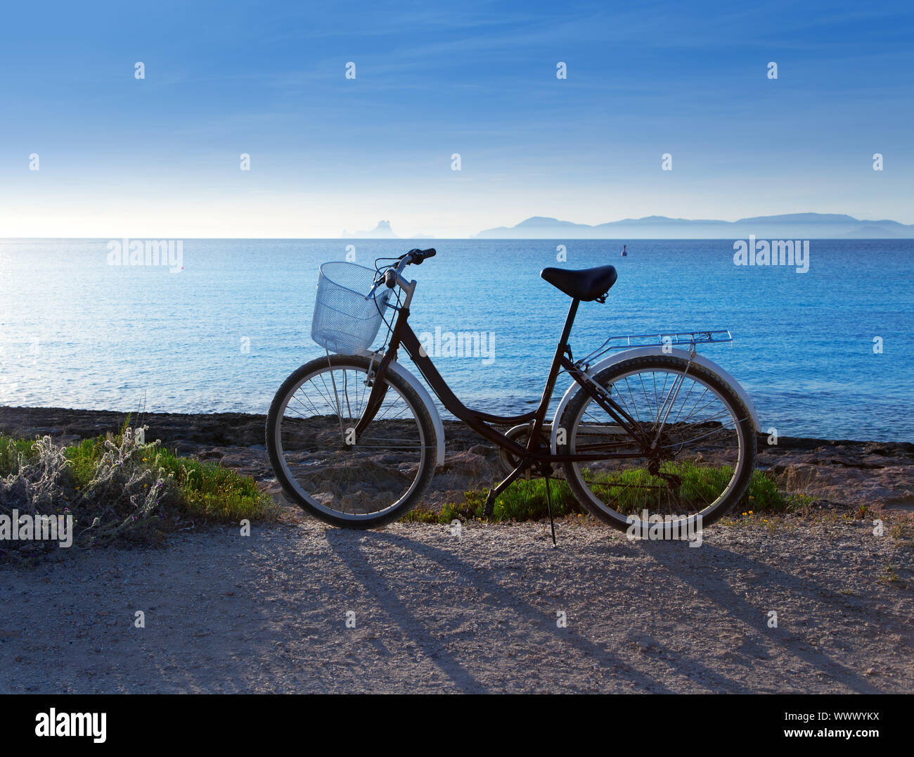 Bicycle in formentera beach on Balearic islands with Ibiza sunset ...