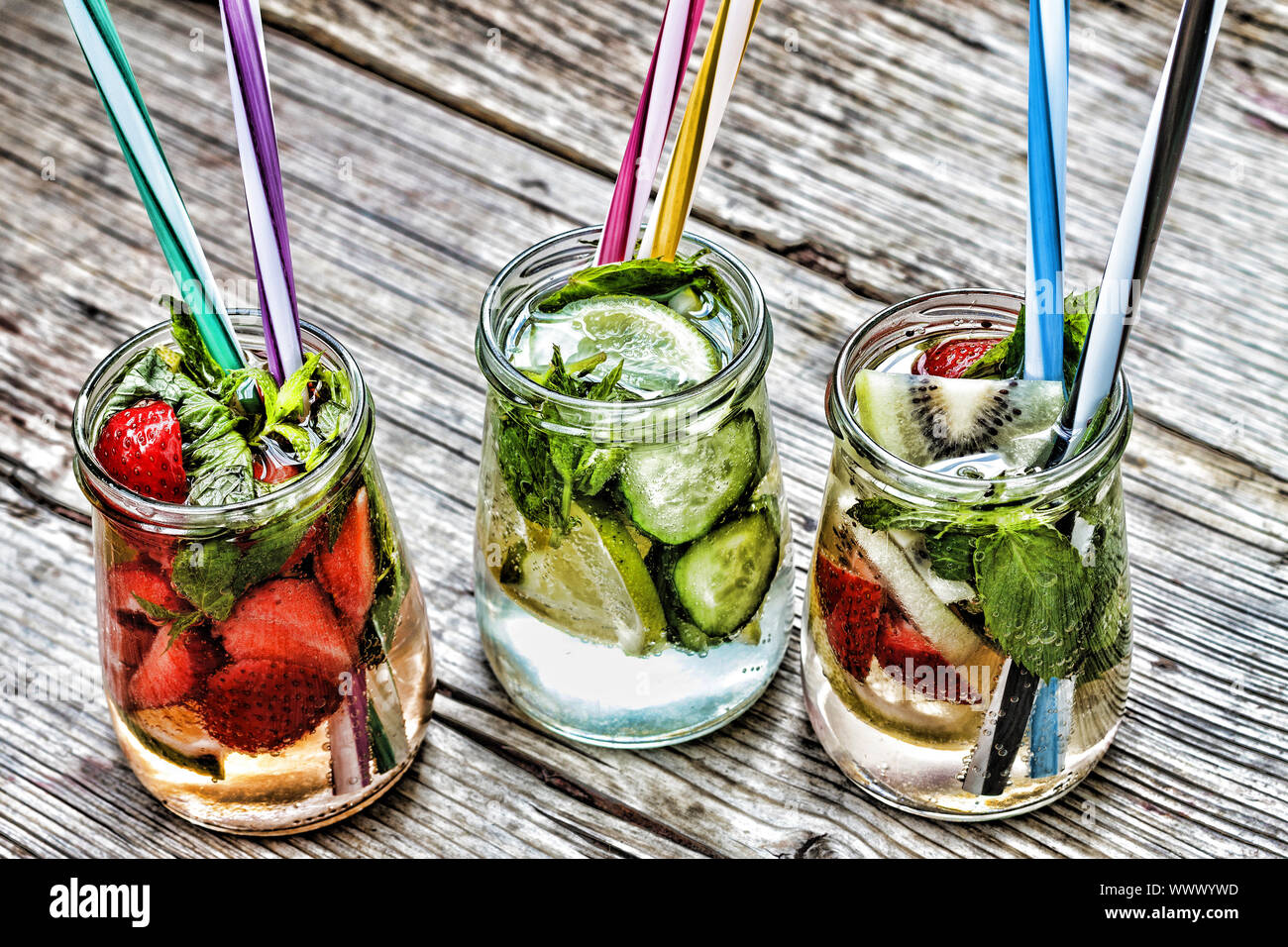 A variety of cold drinks in small bottles with pieces of fruit Stock ...