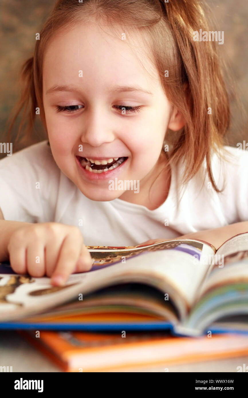 Smart girl reading a book and learns Stock Photo - Alamy