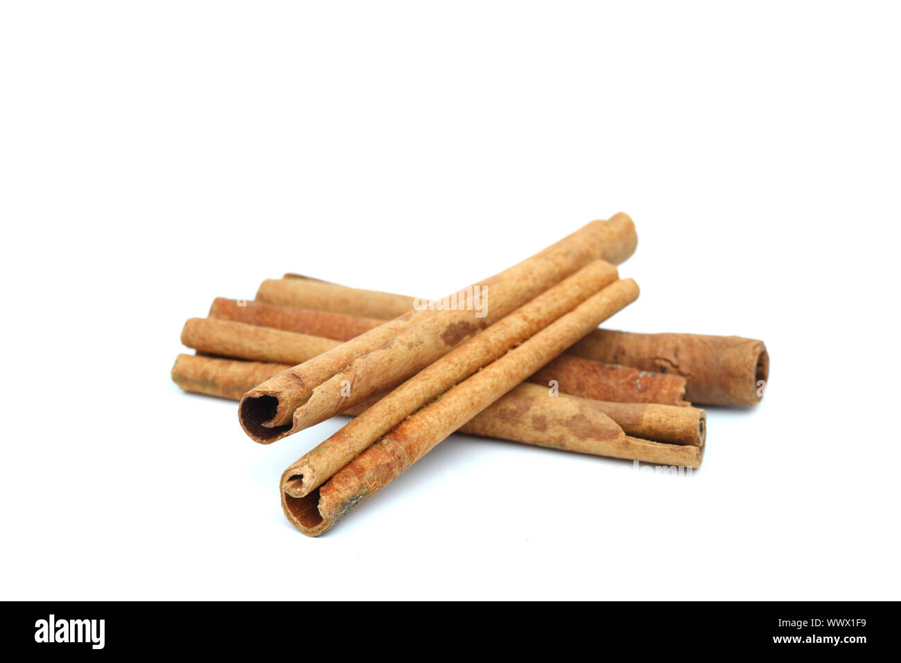 cinnamon pile isolated on white Stock Photo - Alamy