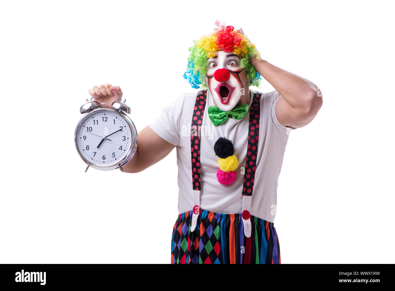 The funny clown with an alarm clock isolated on white background Stock ...