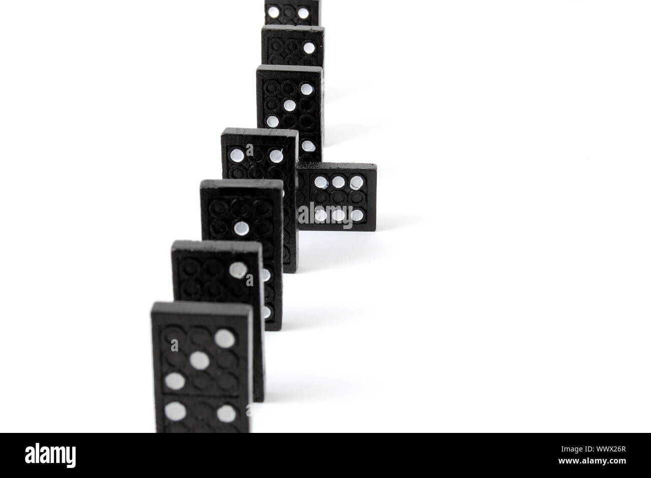 row of dominoes including a special domino stone isolated on white ...