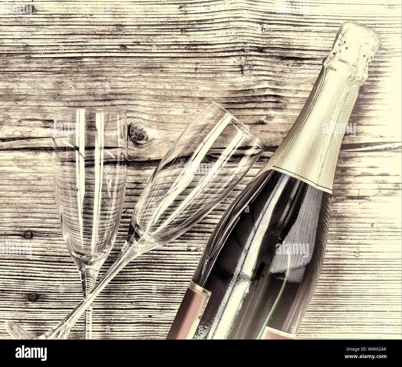Champagne. Champagne bottle and two empty glasses on a wooden ...