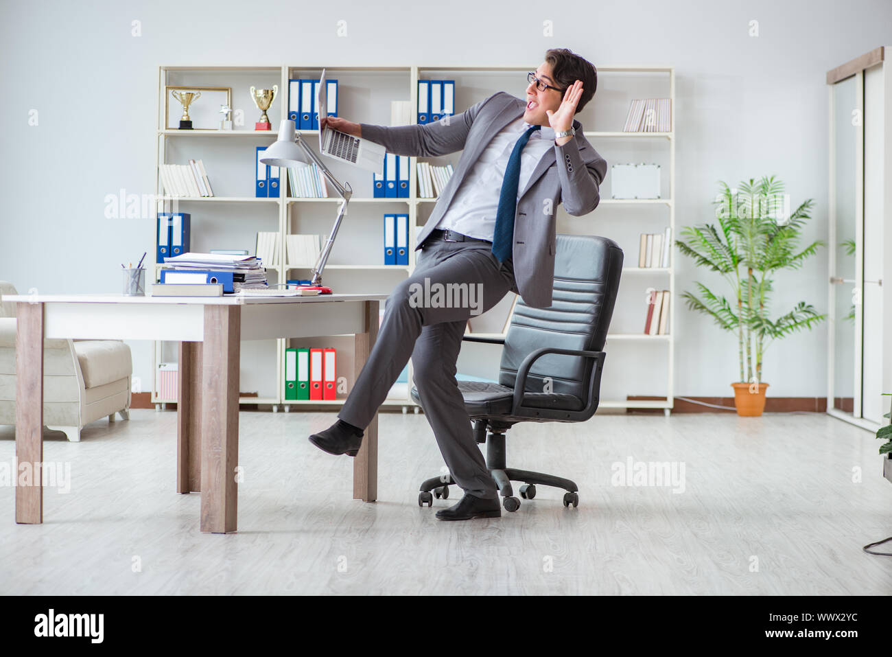 Businessman having fun taking a break in the office at work Stock Photo ...