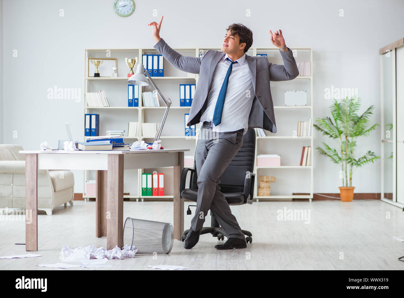 Businessman having fun taking a break in the office at work Stock Photo ...