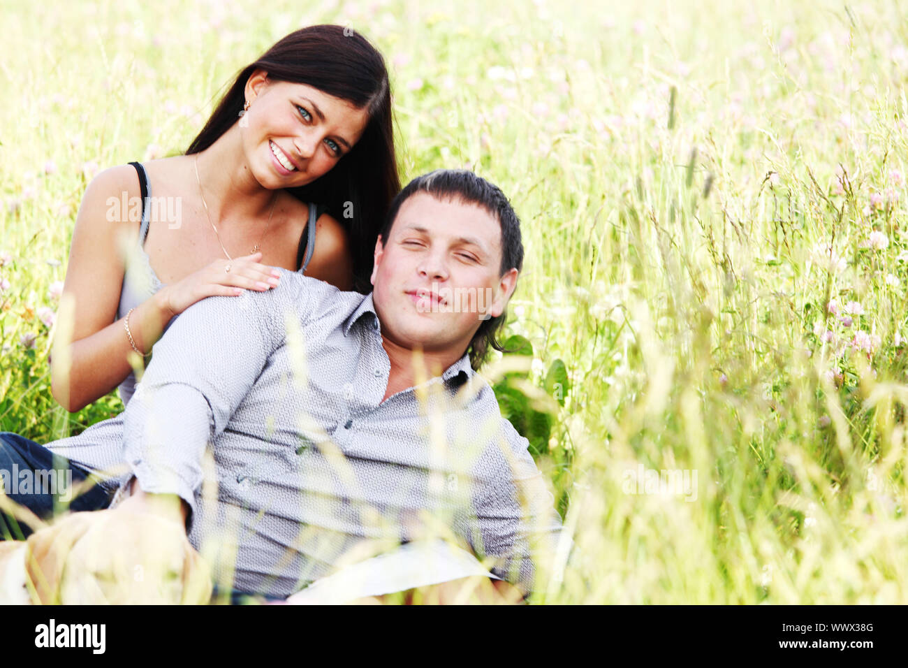 two lovers on grass field Stock Photo - Alamy