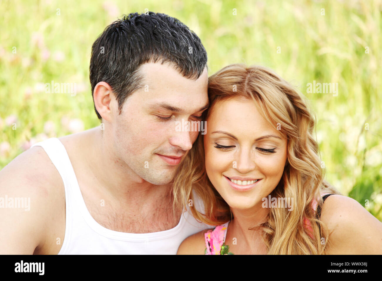 two lovers on grass field Stock Photo - Alamy