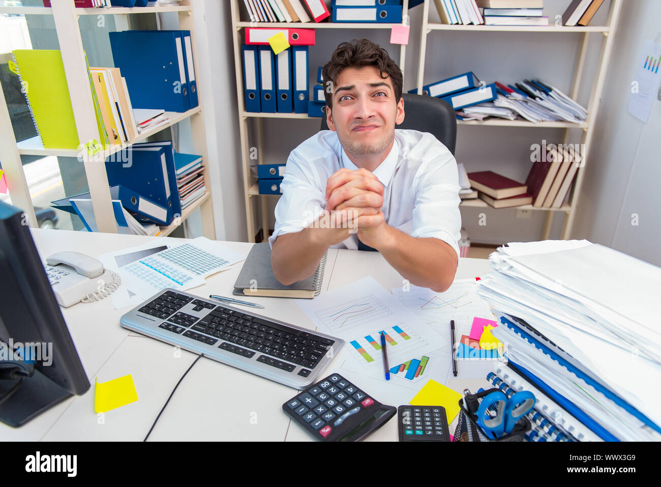 Businessman working in the office with piles of books and papers Stock ...