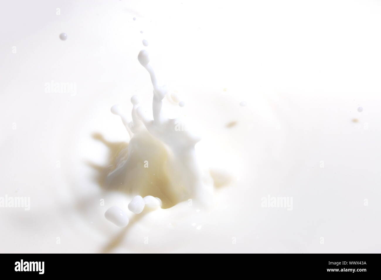 drops of milk splashing in fresh milk Stock Photo - Alamy