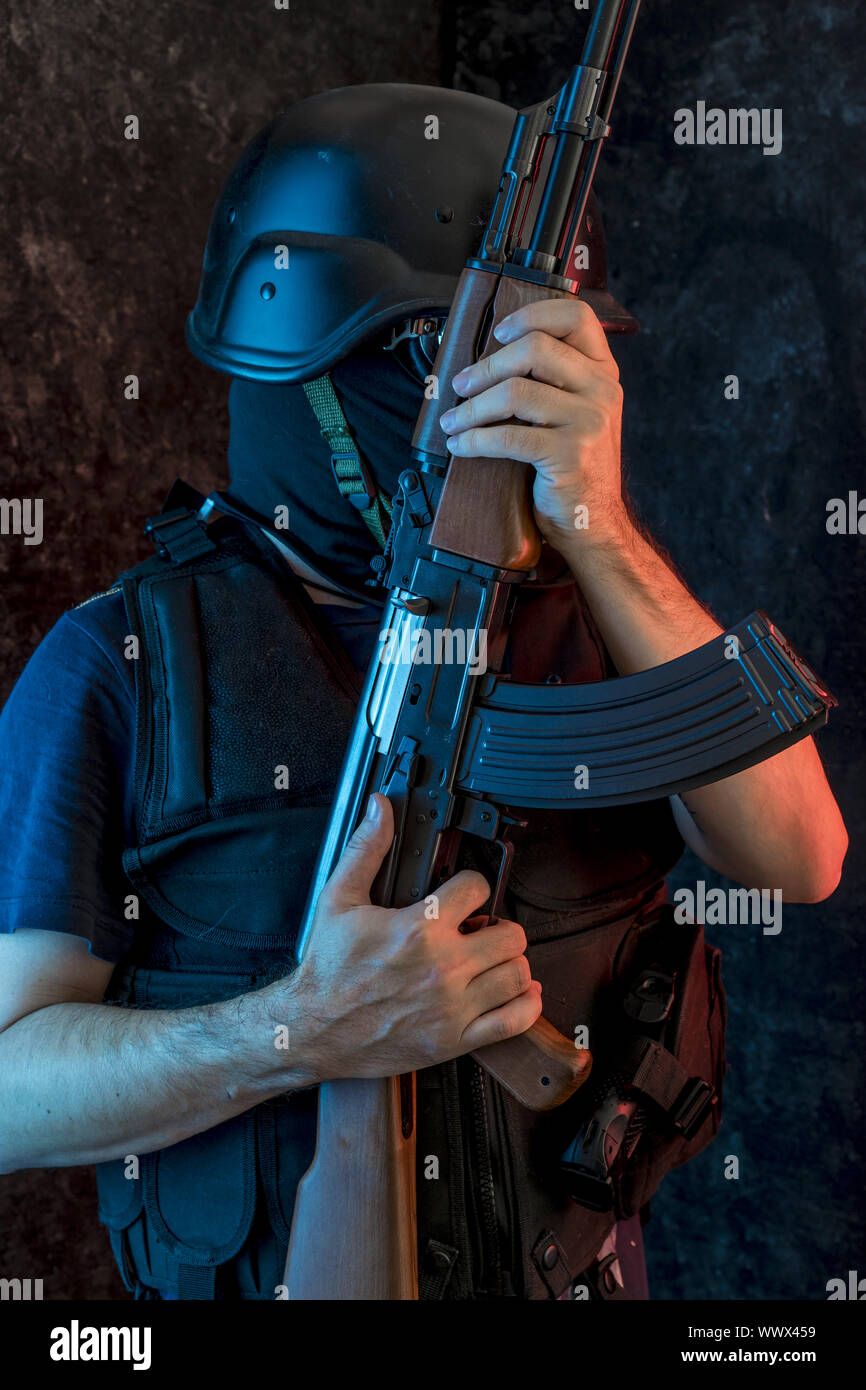 man armed with balaclava and bulletproof vest, gun and shotgun ...