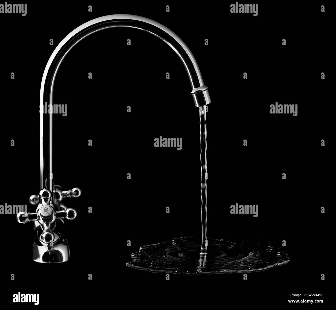 Water tap on black background Stock Photo - Alamy