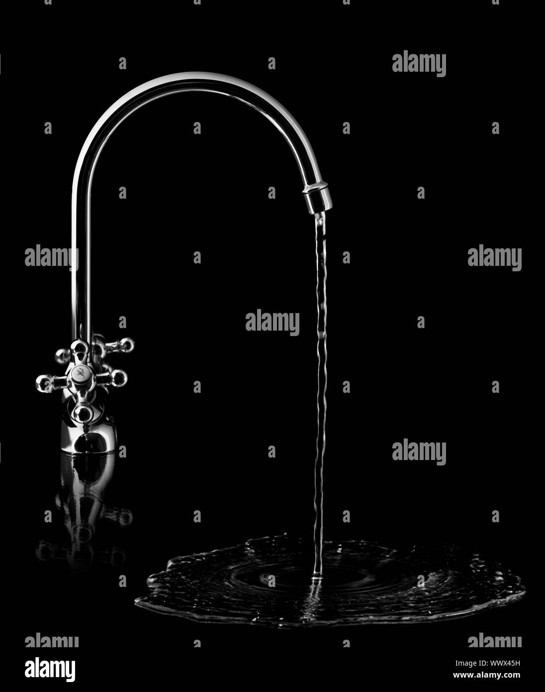 Water tap on black background Stock Photo - Alamy