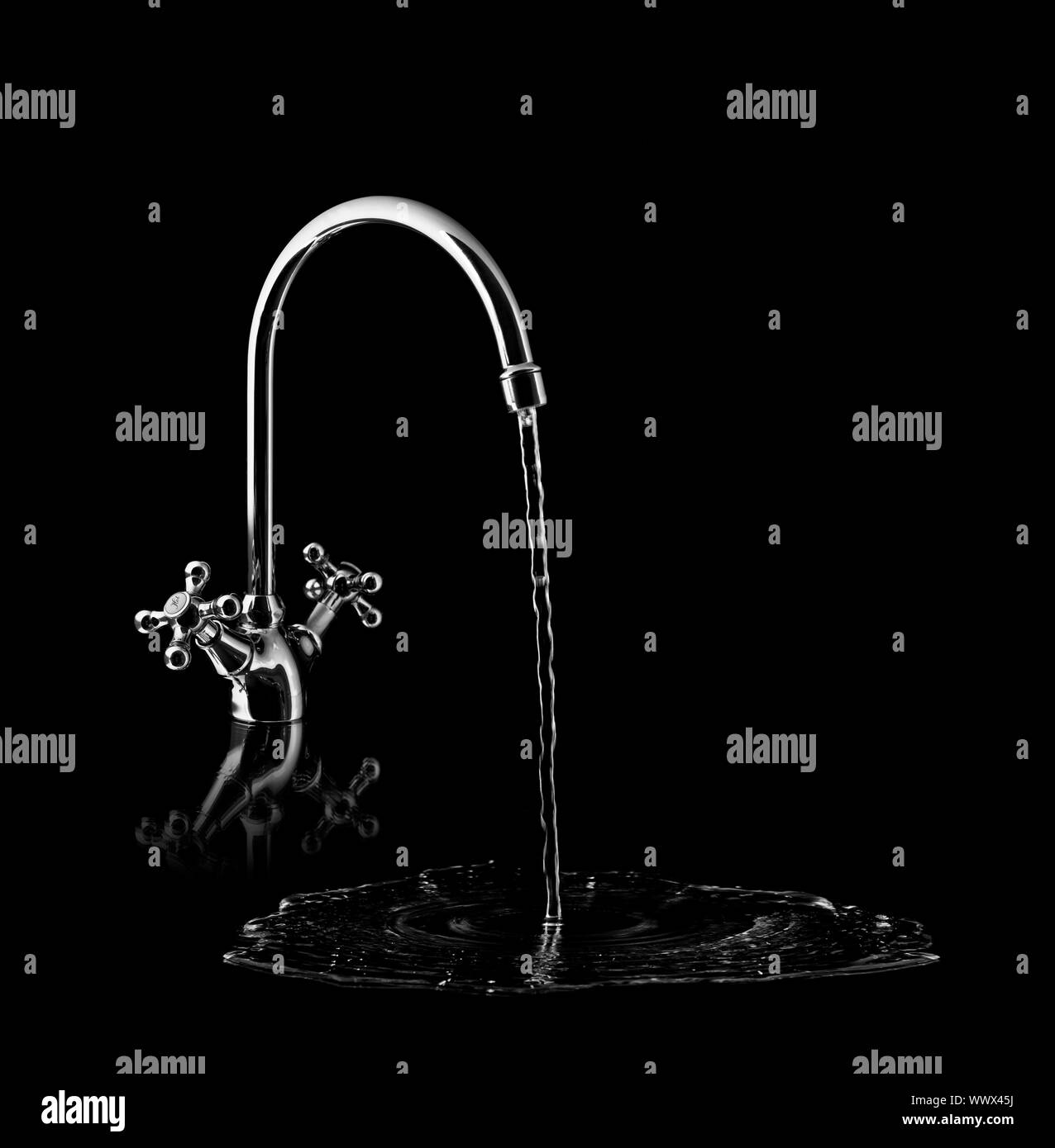 Water tap on black background Stock Photo - Alamy