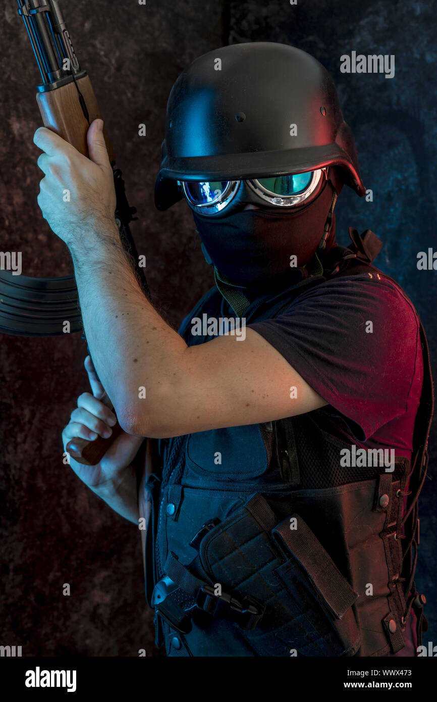 Violence, man armed with balaclava and bulletproof vest, gun and ...