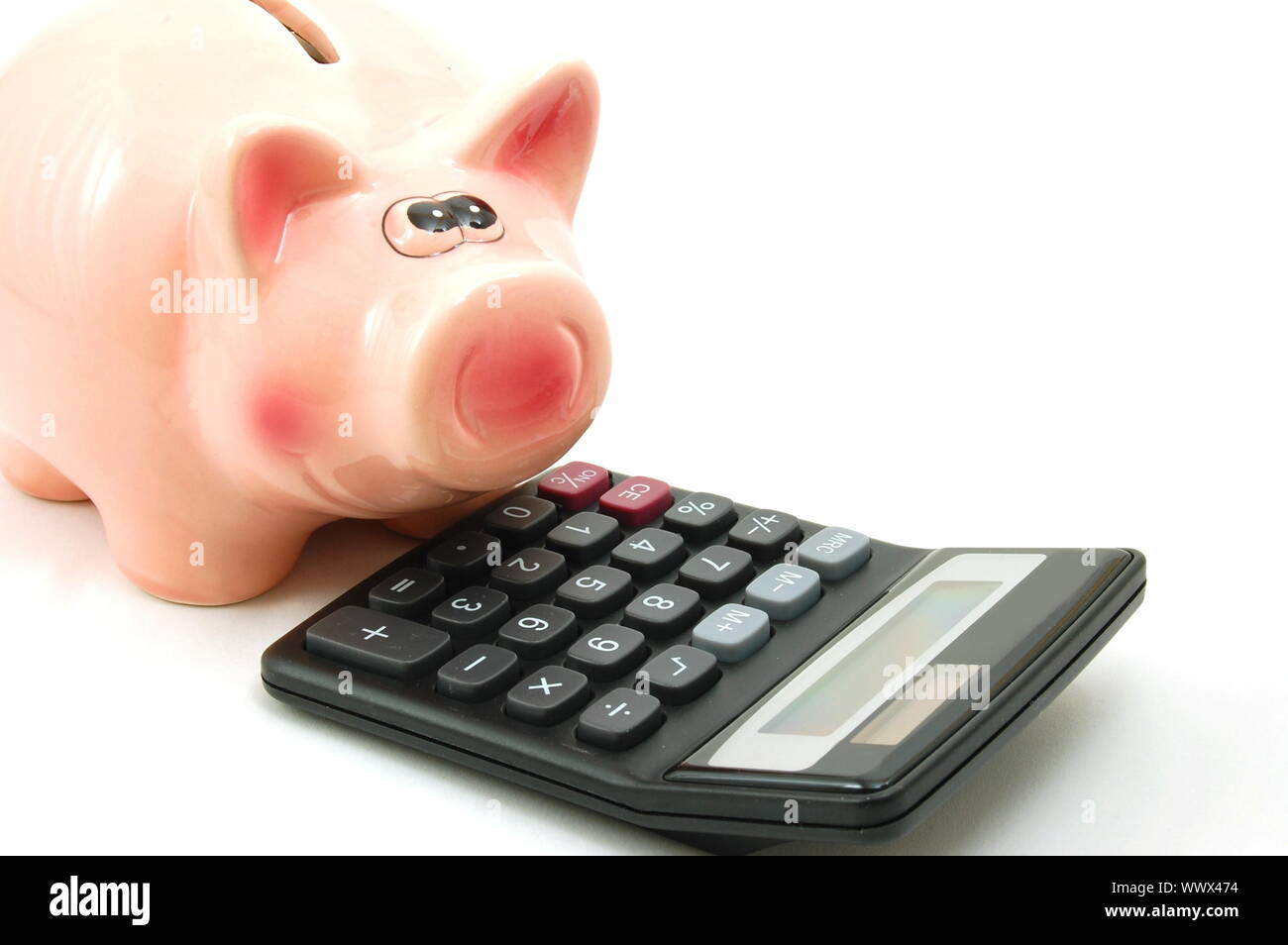 saving money with a piggy bank isolated on white Stock Photo - Alamy