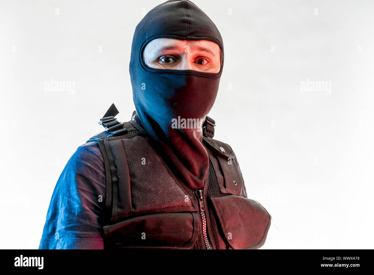 Thief, man armed with balaclava and bulletproof vest, gun and shotgun ...