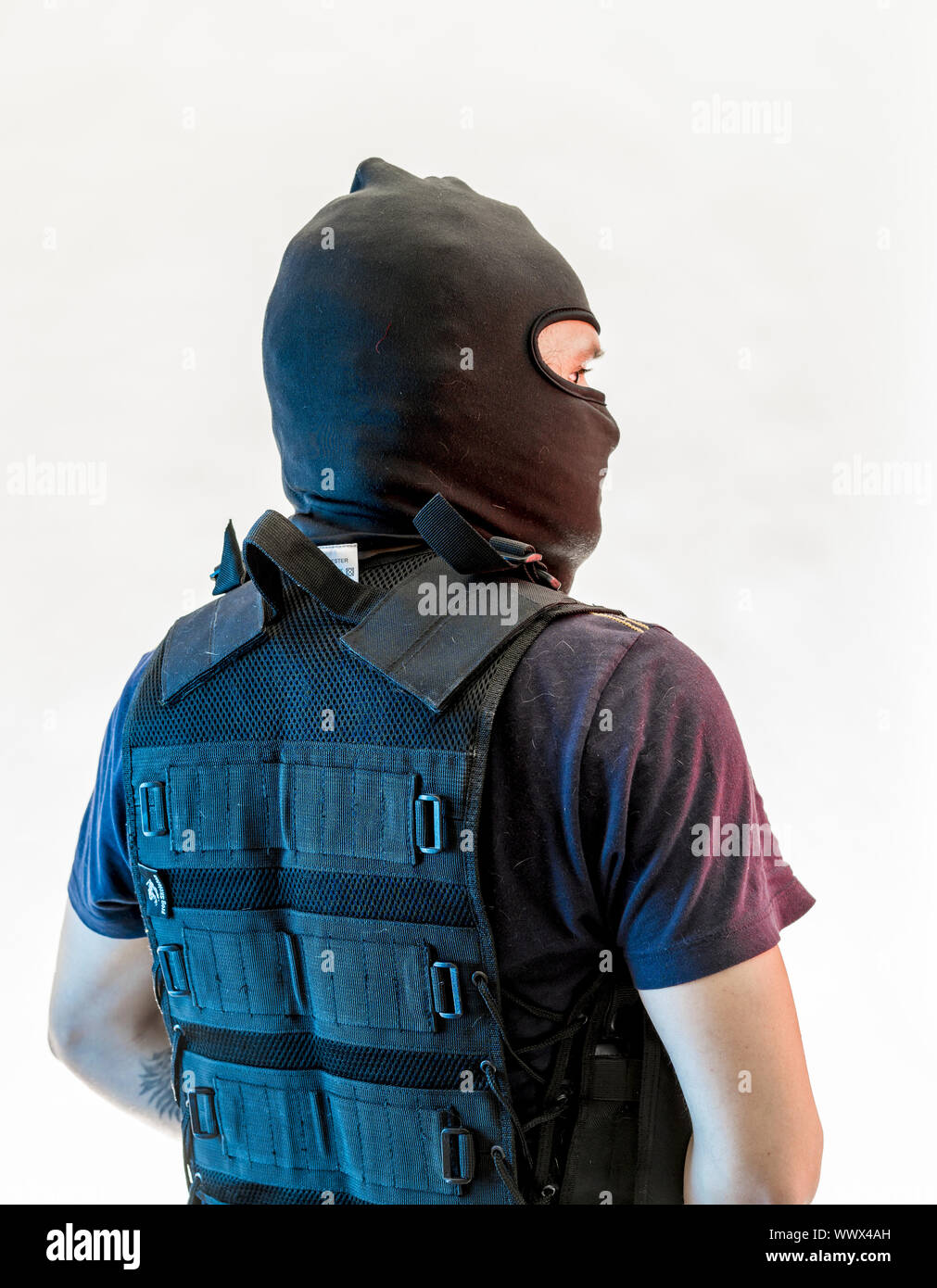 Secret, man armed with balaclava and bulletproof vest, gun and shotgun ...