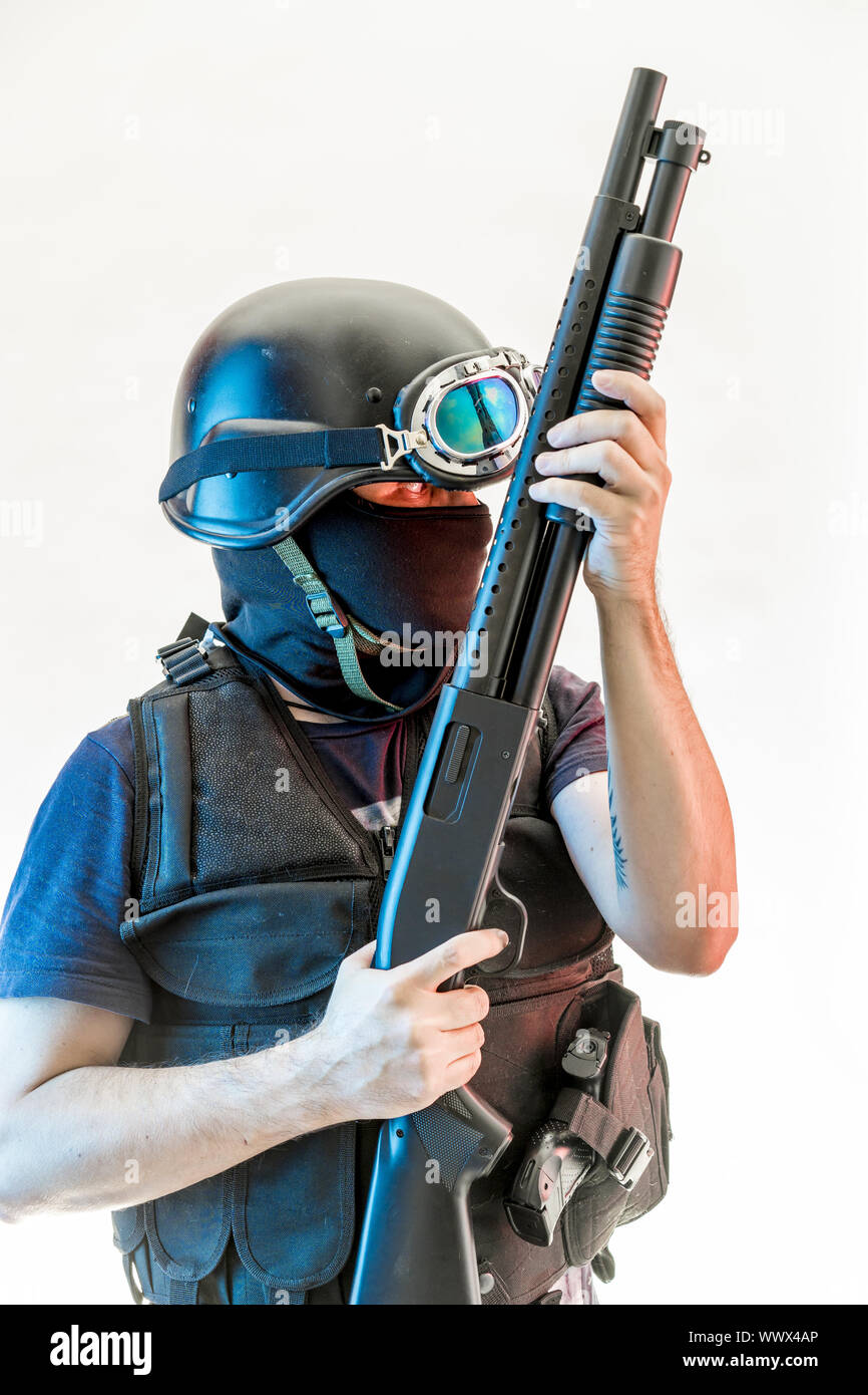man armed with balaclava and bulletproof vest, gun and shotgun ...