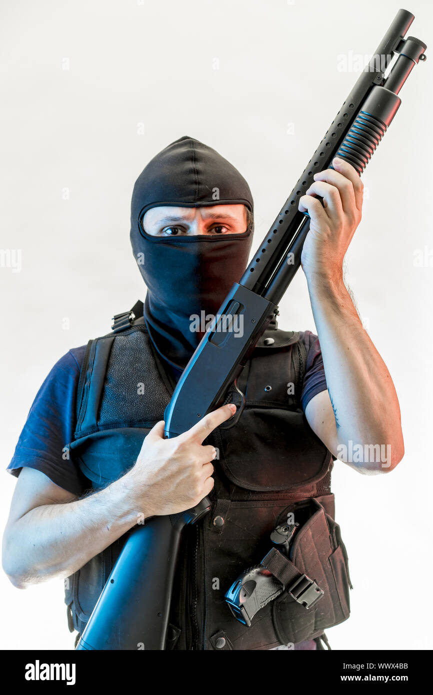 Murderer, man armed with balaclava and bulletproof vest, gun and ...