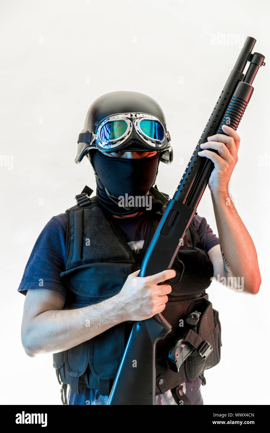man armed with balaclava and bulletproof vest, gun and shotgun ...