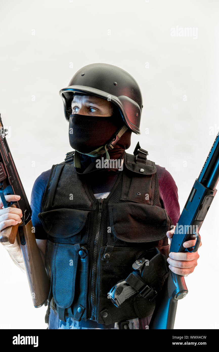 Violence, man armed with balaclava and bulletproof vest, gun and ...