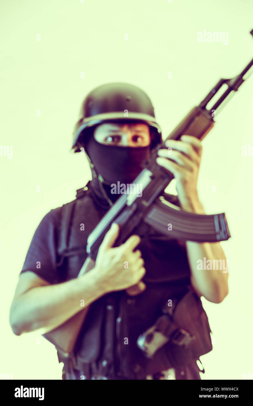 man armed with balaclava and bulletproof vest, gun and shotgun ...