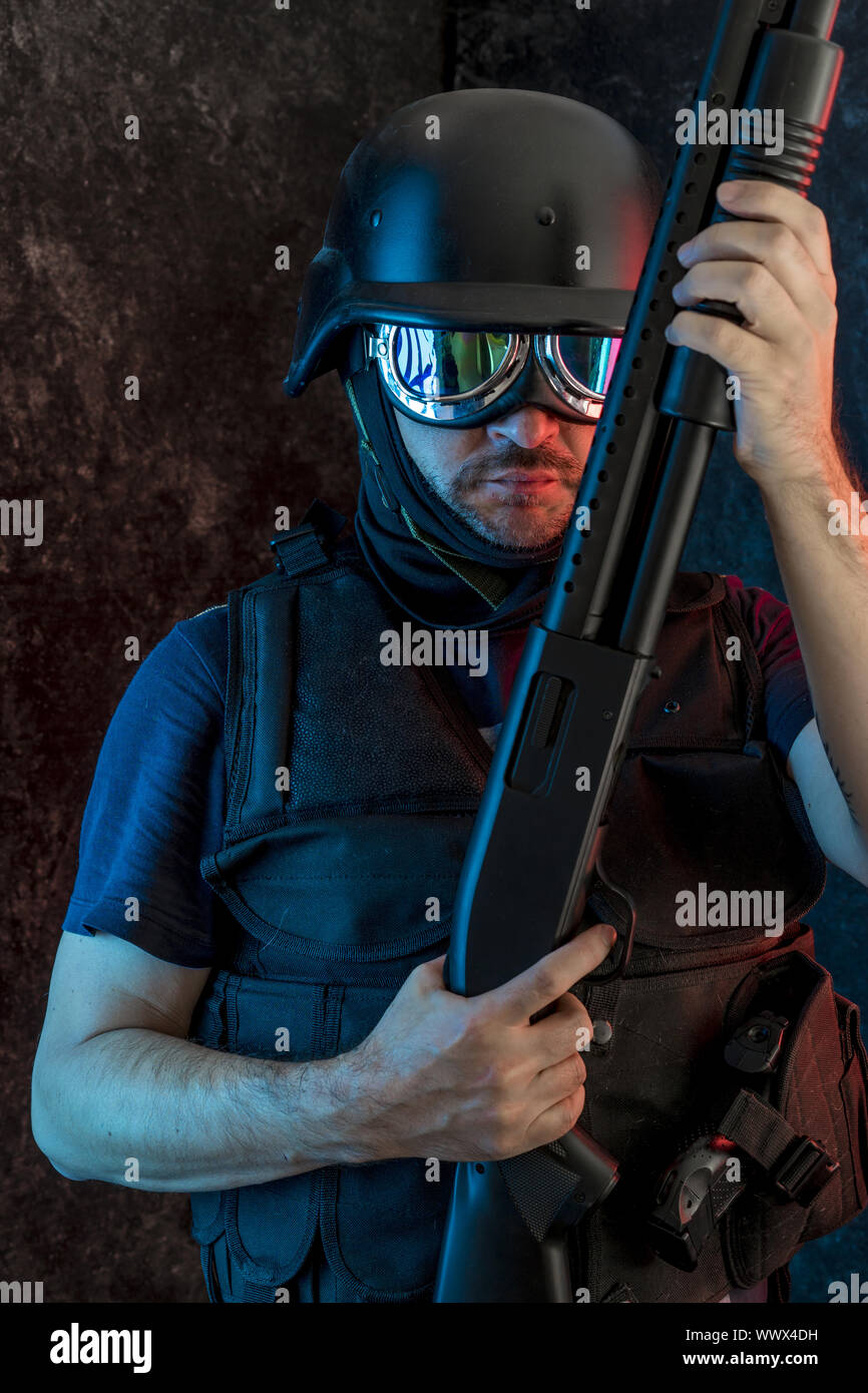 man armed with balaclava and bulletproof vest, gun and shotgun ...