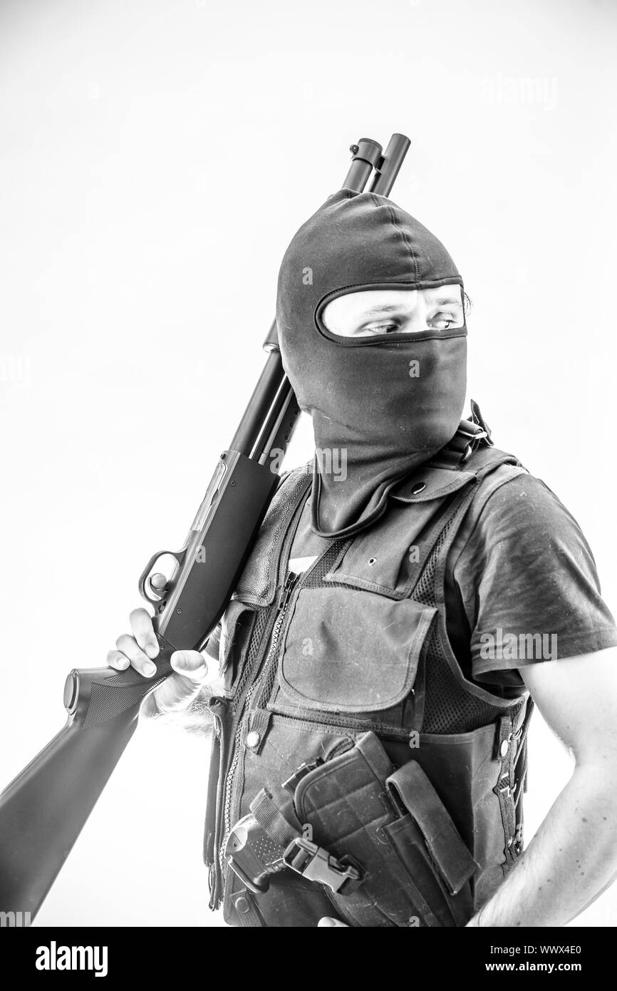 man armed with balaclava and bulletproof vest, gun and shotgun ...