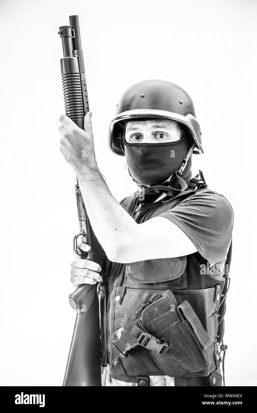 man armed with balaclava and bulletproof vest, gun and shotgun ...