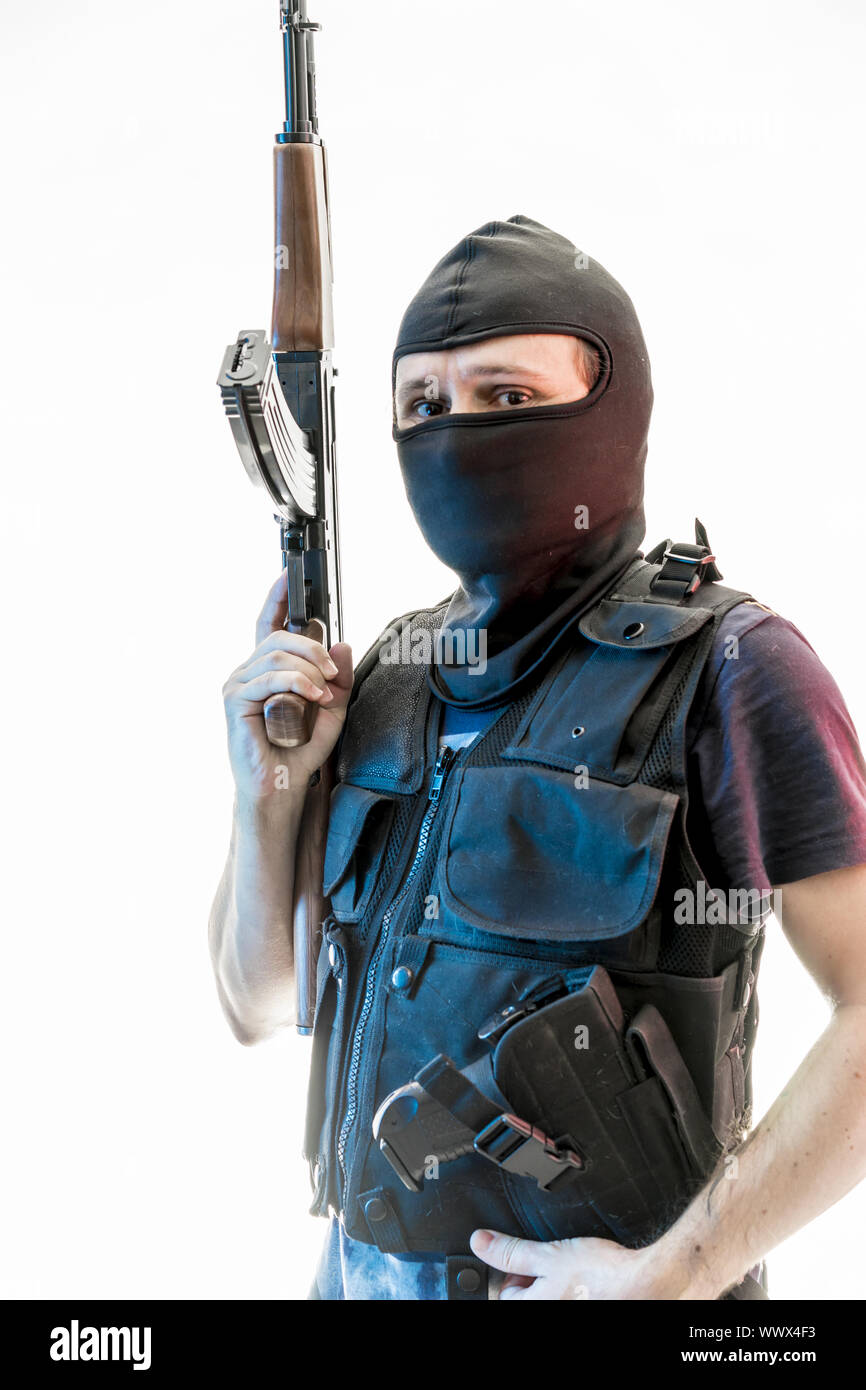 man armed with balaclava and bulletproof vest, gun and shotgun ...