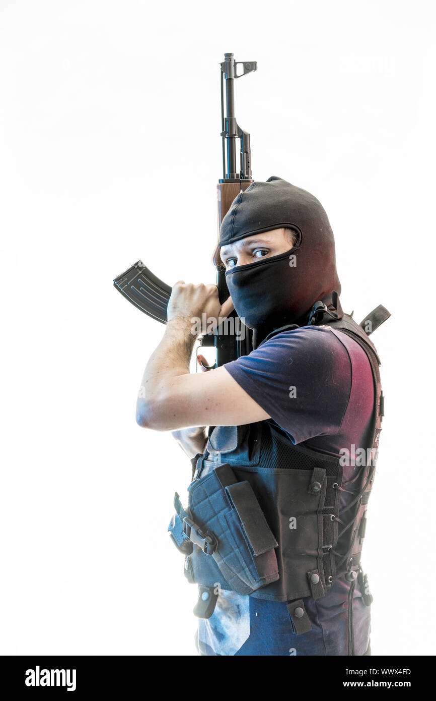 man armed with balaclava and bulletproof vest, gun and shotgun ...