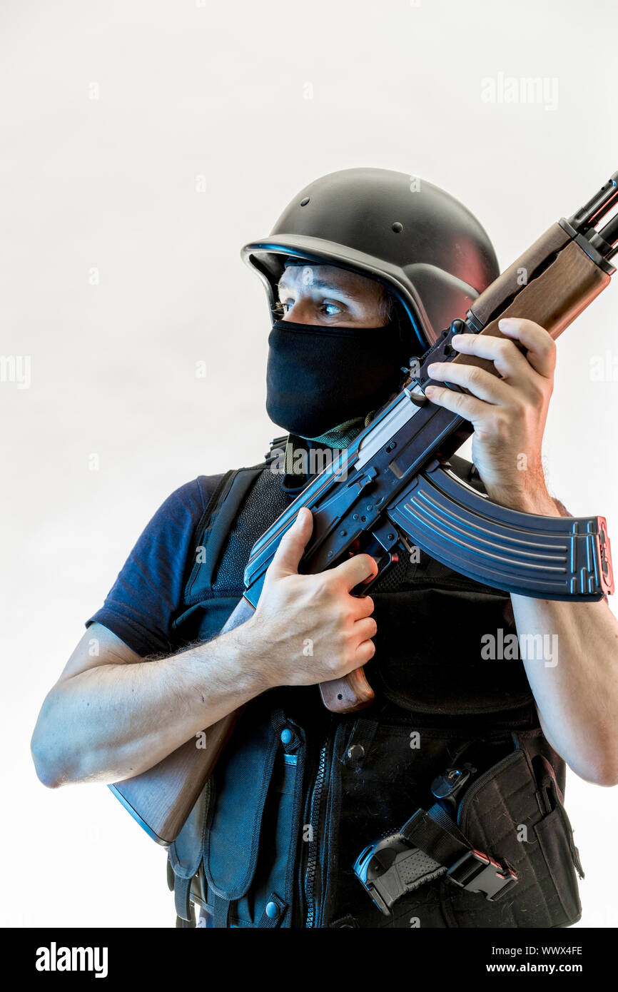 man armed with balaclava and bulletproof vest, gun and shotgun ...