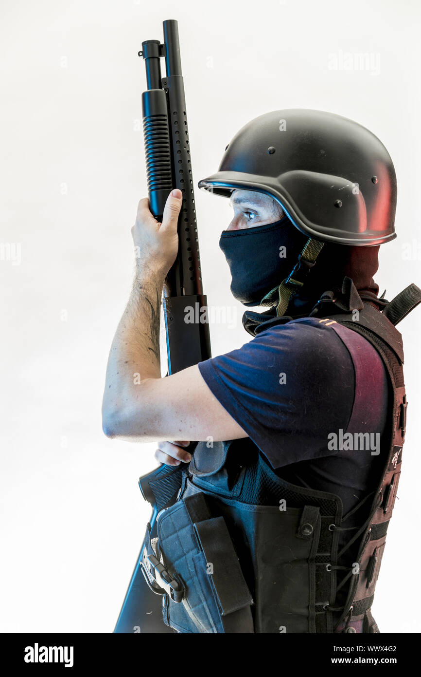 Violence, man armed with balaclava and bulletproof vest, gun and ...