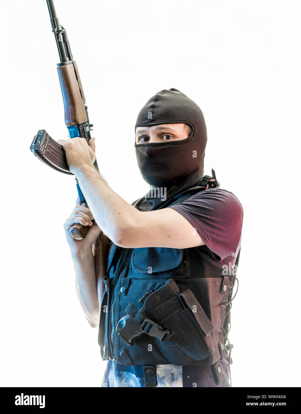 Secret, man armed with balaclava and bulletproof vest, gun and shotgun ...