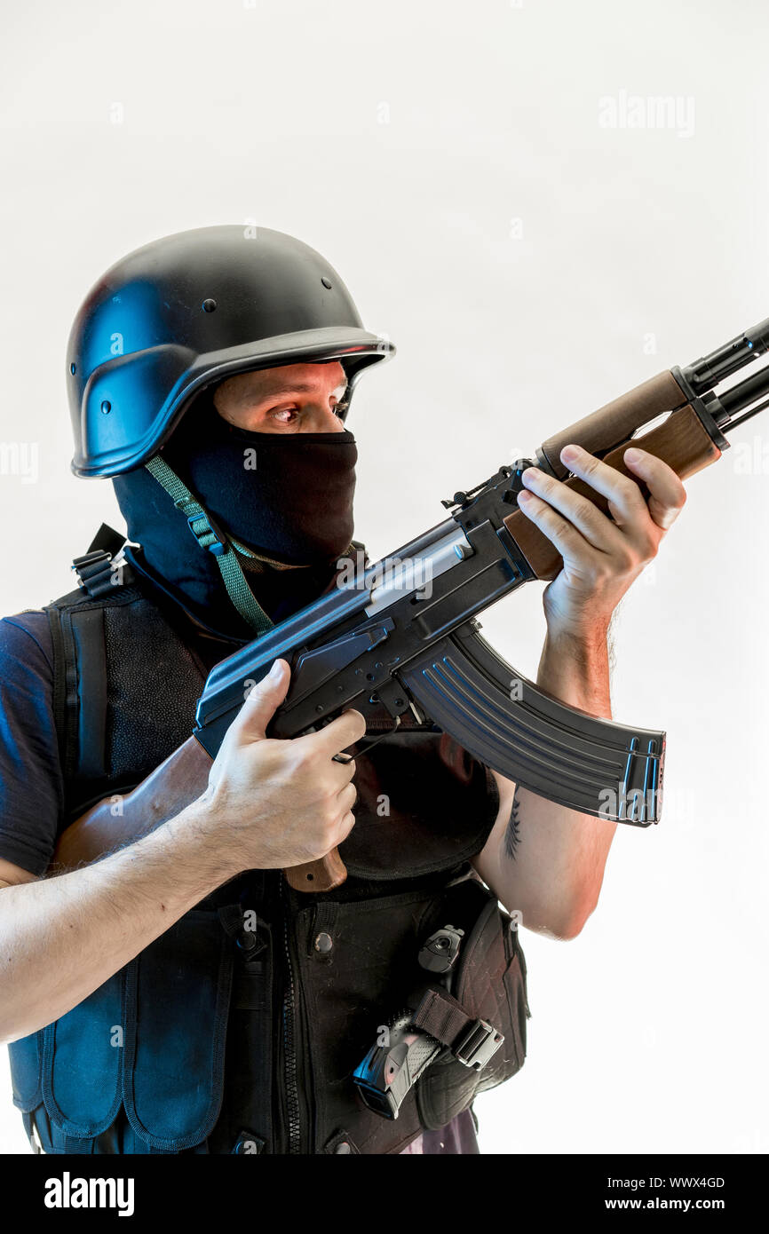 man armed with balaclava and bulletproof vest, gun and shotgun ...