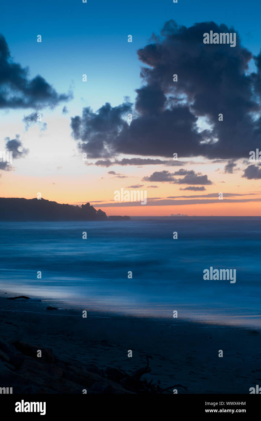 A beach during sunset with glowing sky Stock Photo - Alamy